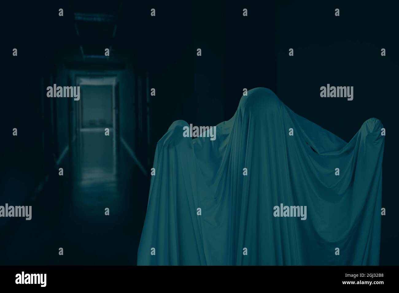 The man is in white clothes and shows a scary looking face at a creepy ...