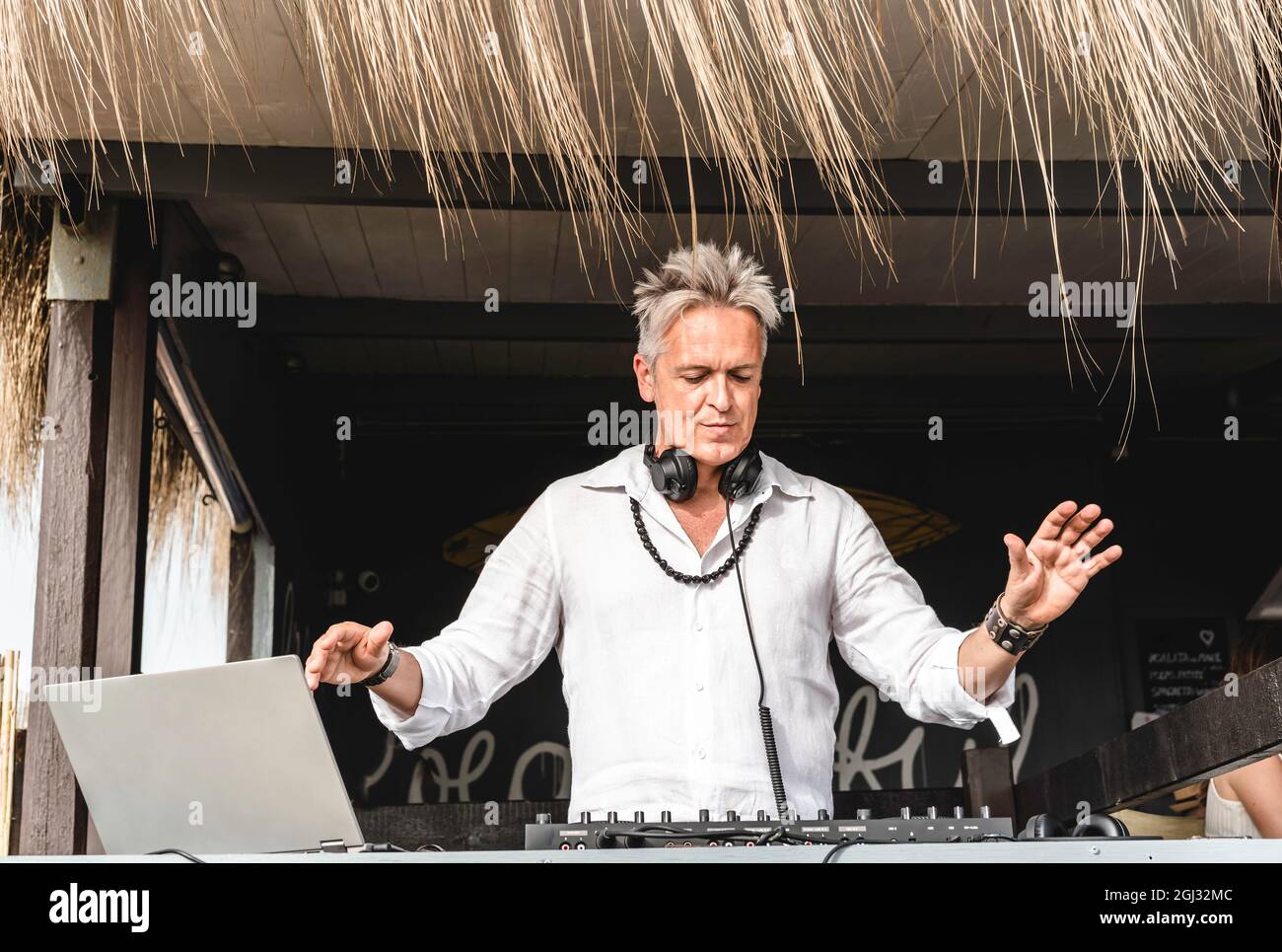 Disc jockey playing music for tourist people at club party outdoors on ...