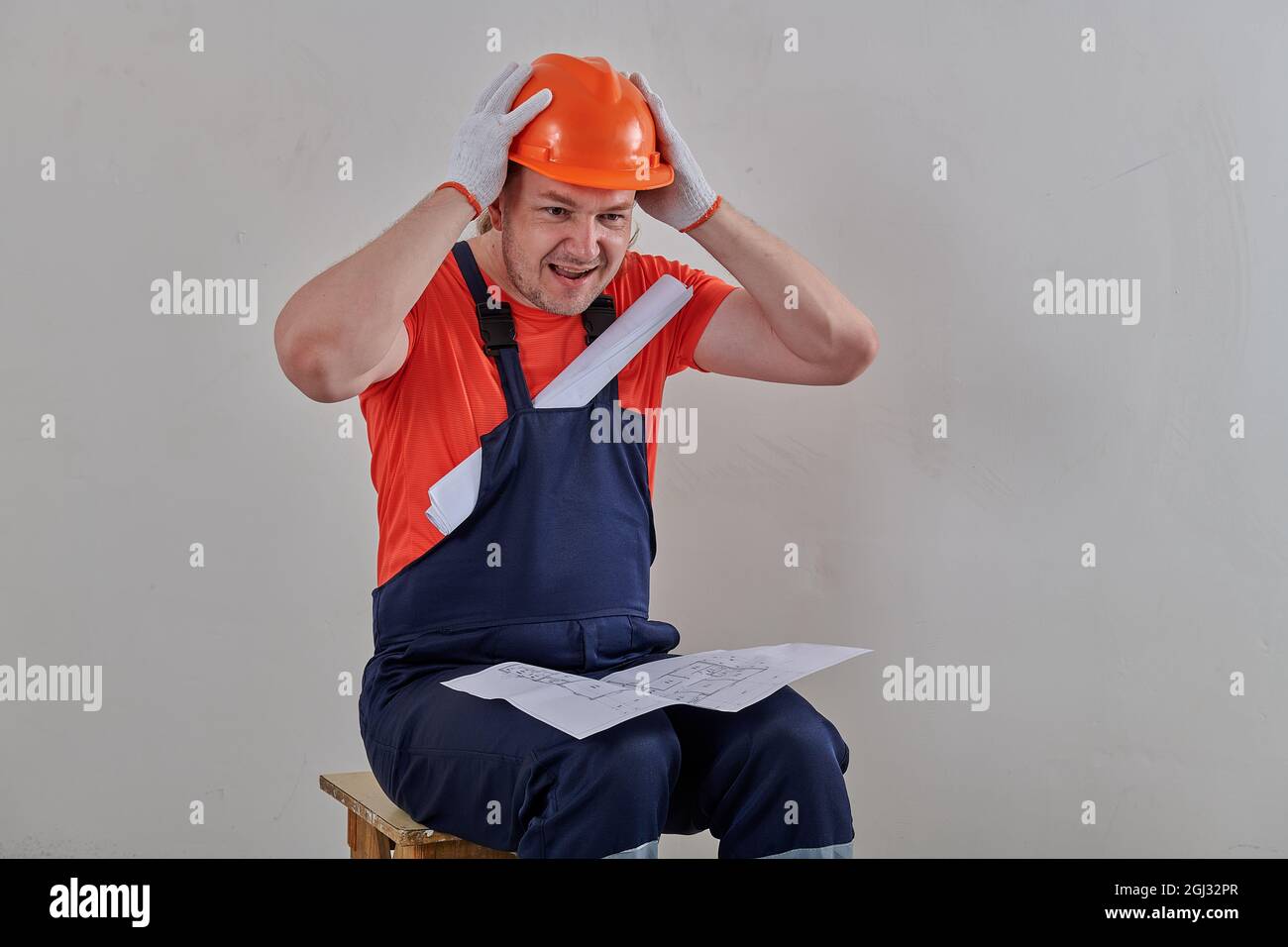 a very angry engineer examines the blueprints of the project Stock ...