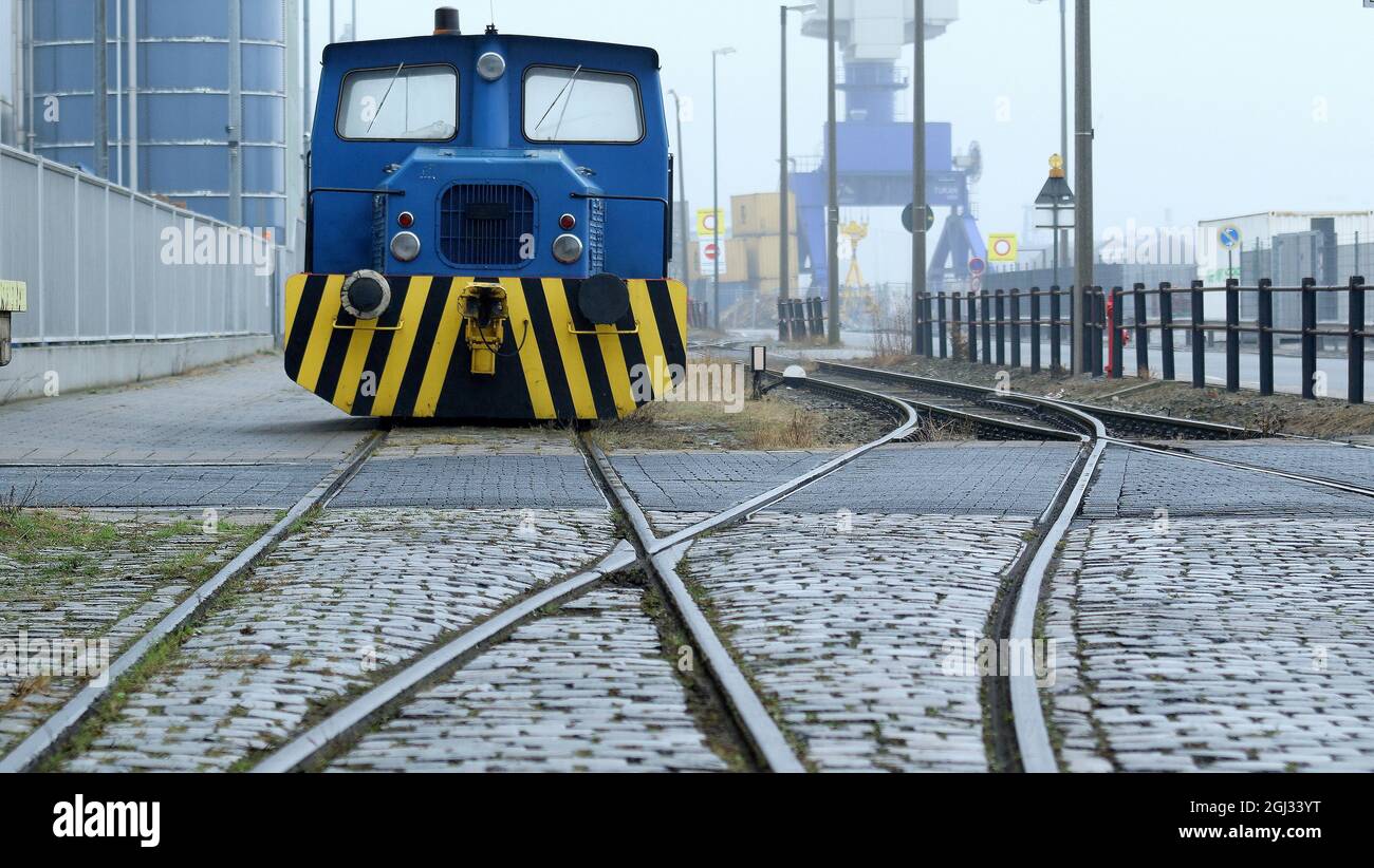 Blue-yellow striped train in a railroad Stock Photo - Alamy