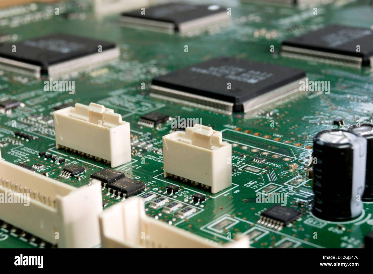 Close up motherboard showing capacitors, plugs and microprocessors ...
