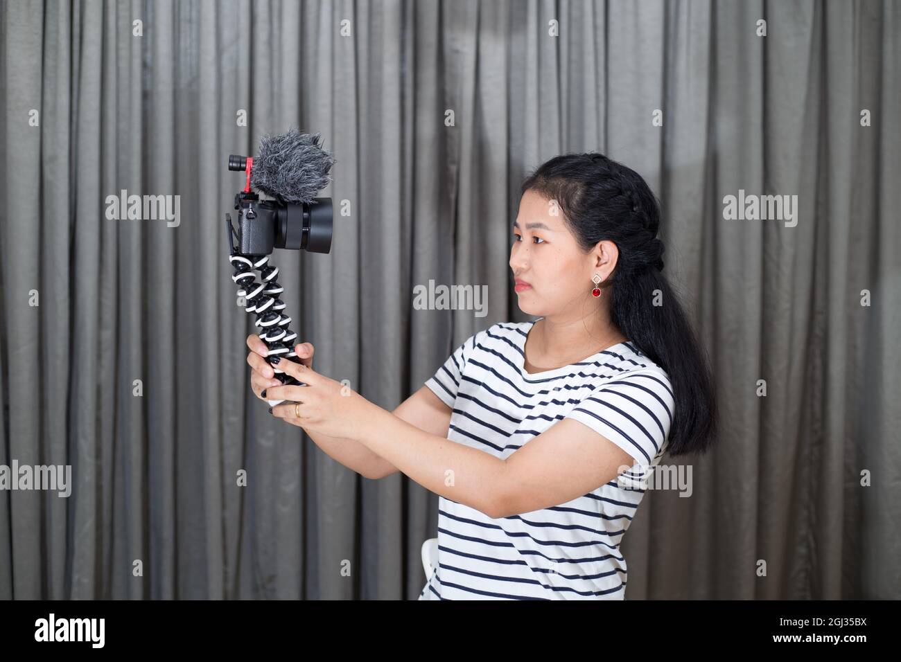 Beautiful woman taking a self-photo with a camera Stock Photo - Alamy