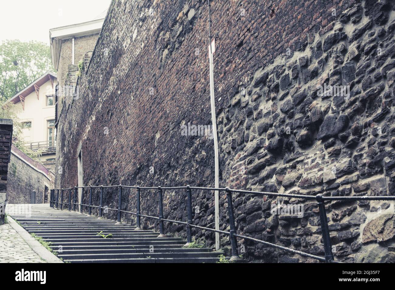 View of Stairs of Rue Peri public area and an old wall in Liege ...