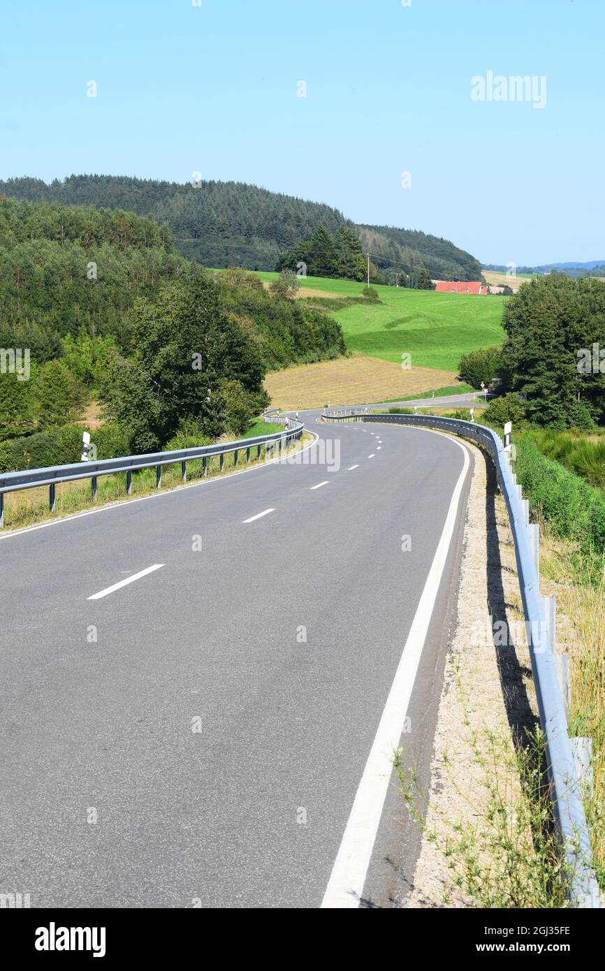 wide road in the Eifel, with weird curves Stock Photo - Alamy