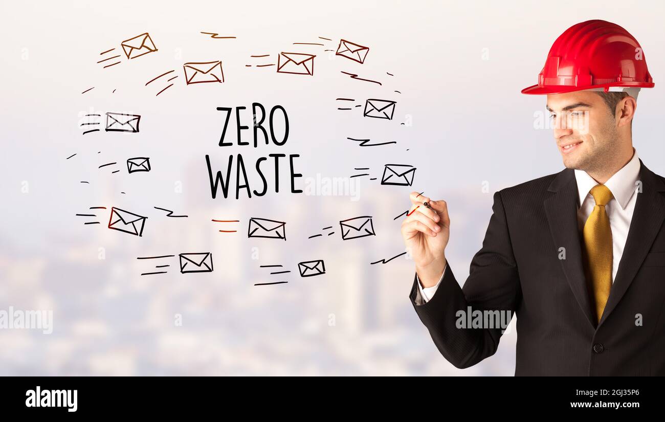 Young businessman with helmet drawing sale sign Stock Photo - Alamy