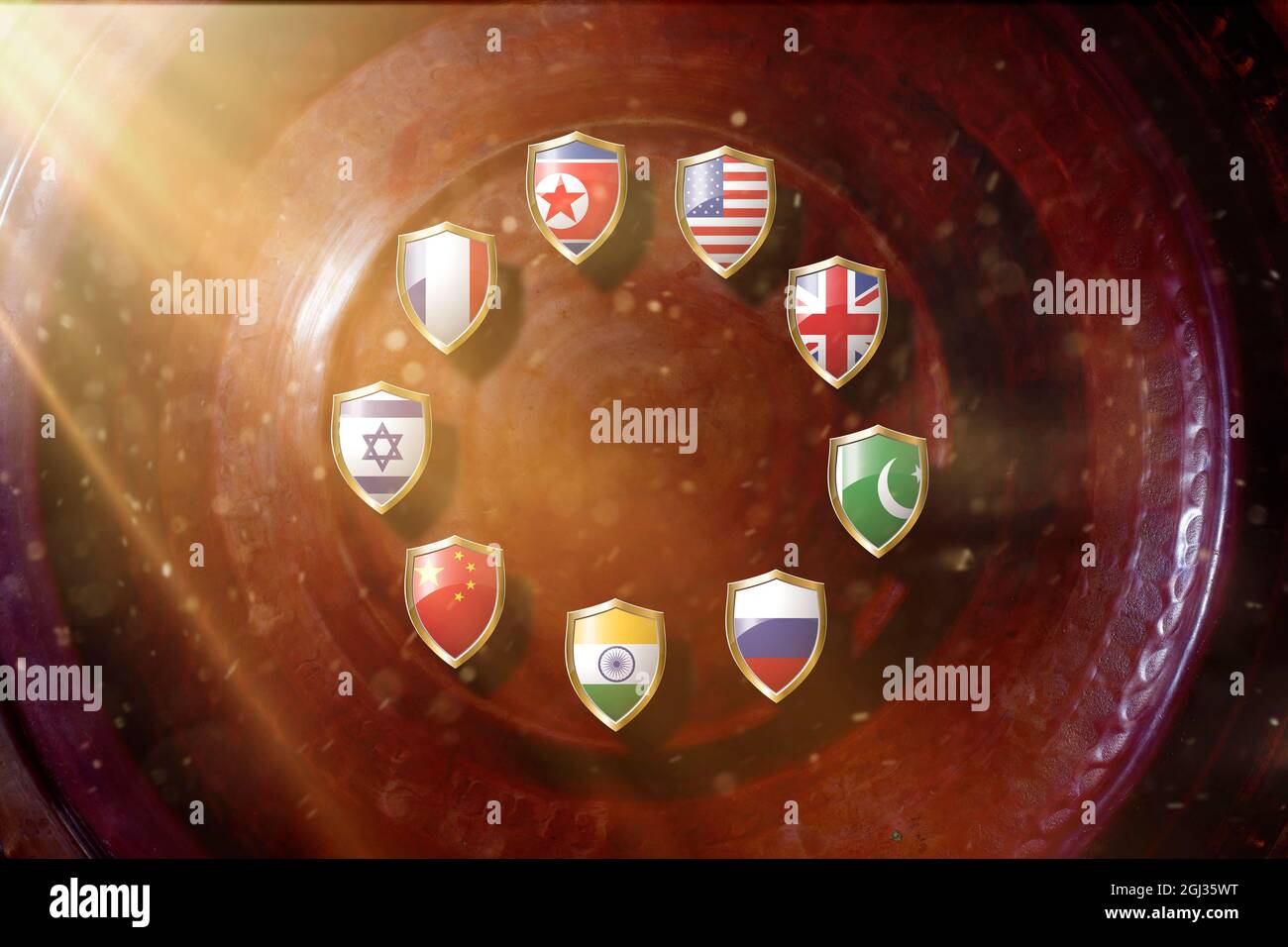 nuclear power countries flag in golden shield on copper texture ...