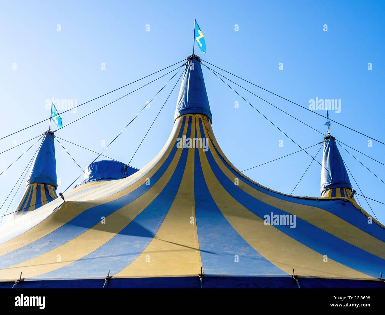 Shot of the top of a blue and yellow circus tent and the blue sky Stock ...