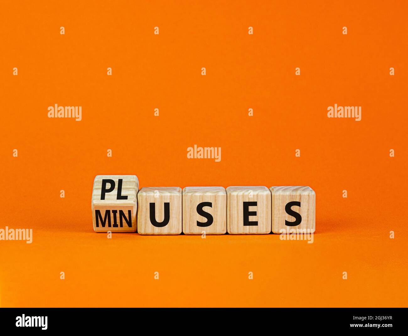Pluses and minuses symbol. Turned a wooden cube and changed the word ...
