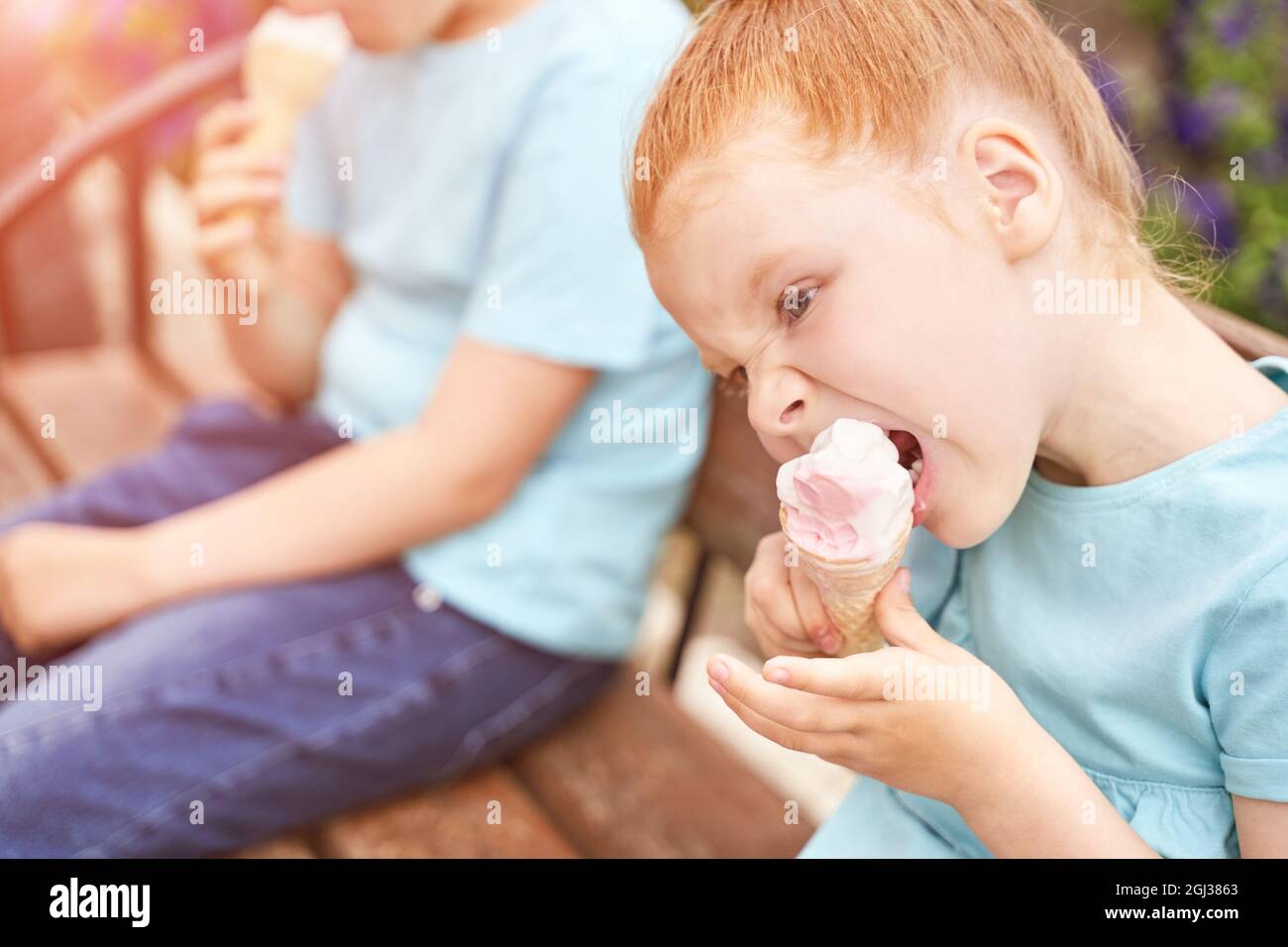 Pretty fun kid eating ice cream at park. Vacation concept. Staycation ...