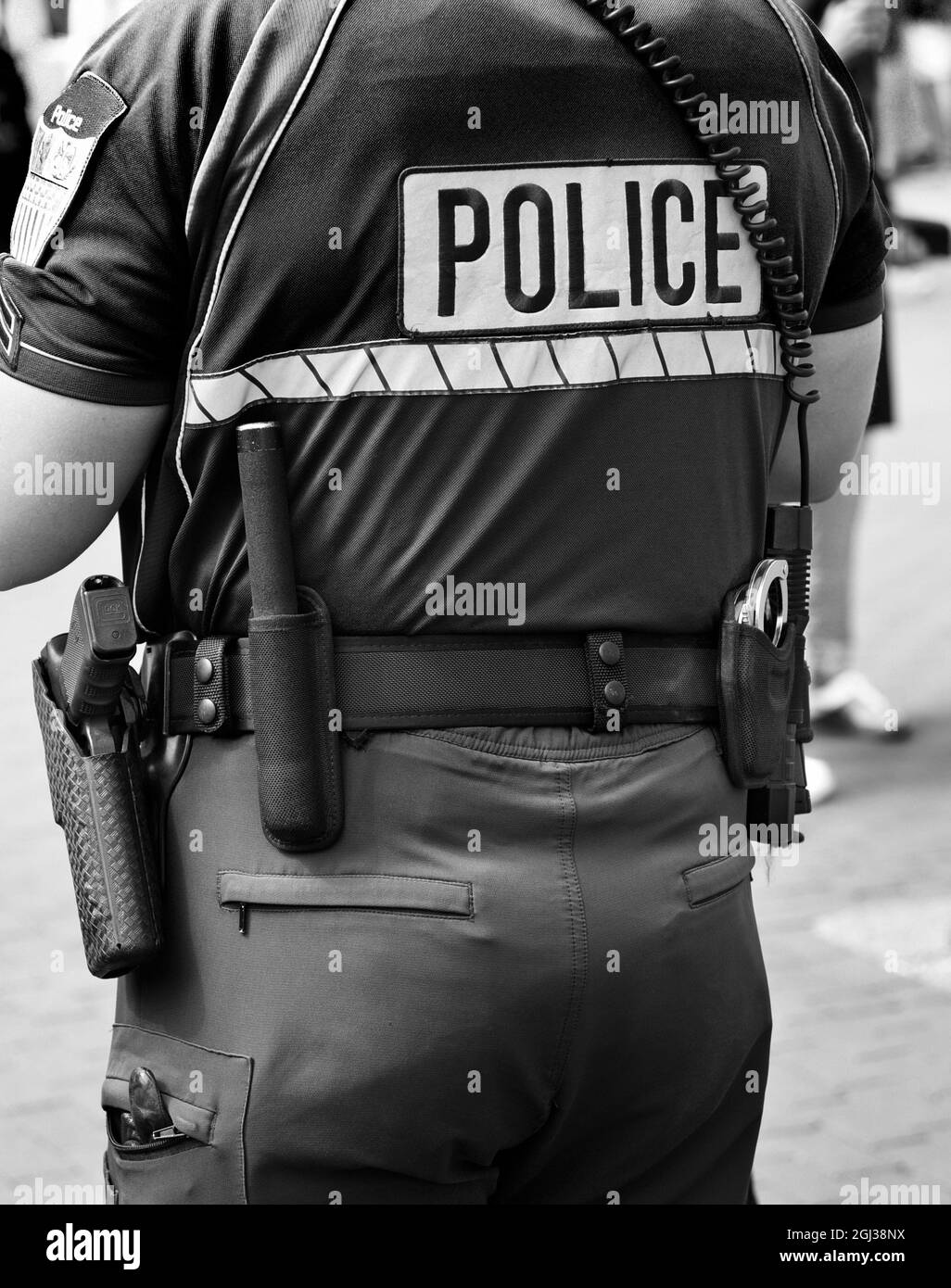 A police officer watches over a crowd gathered for an outdoor arts ...