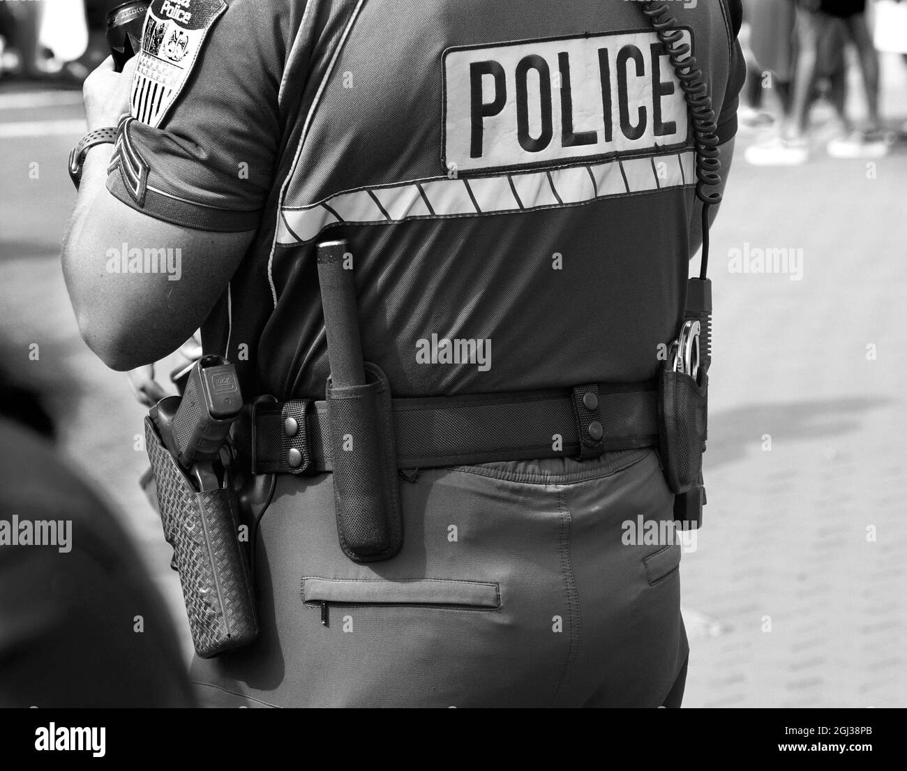 A police officer watches over a crowd gathered for an outdoor arts ...