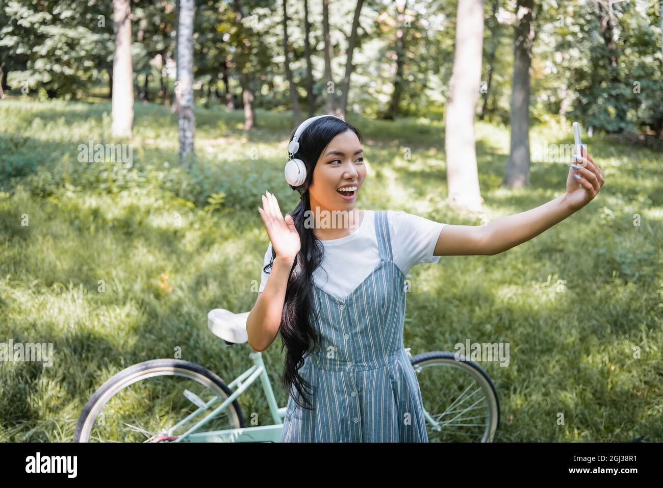 Young asian woman waving hand hi-res stock photography and images - Alamy