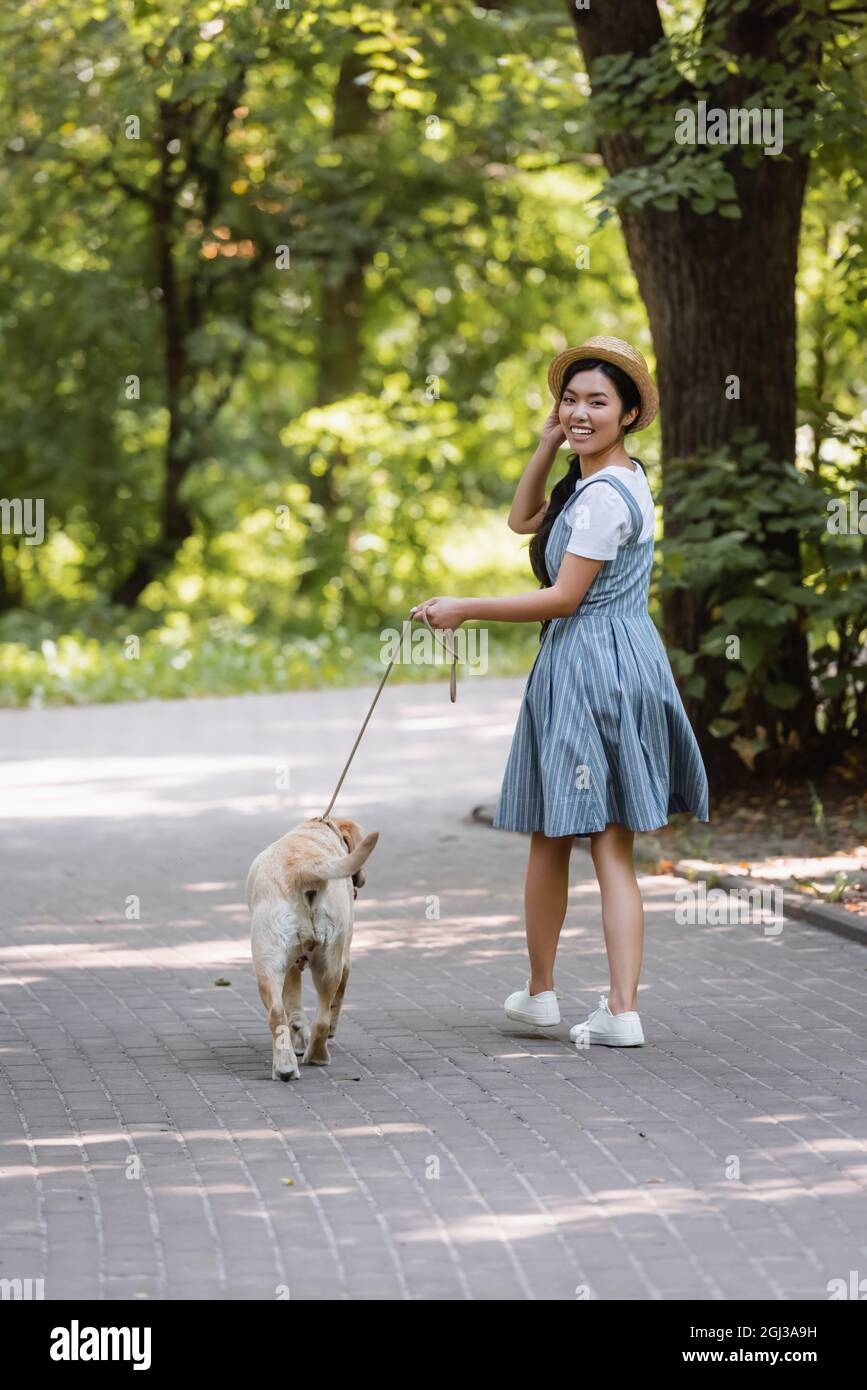 Asian woman walking her dog hi-res stock photography and images - Alamy