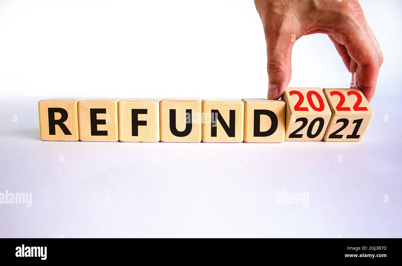 Planning 2022 refund new year symbol. Businessman turns wooden cubes ...