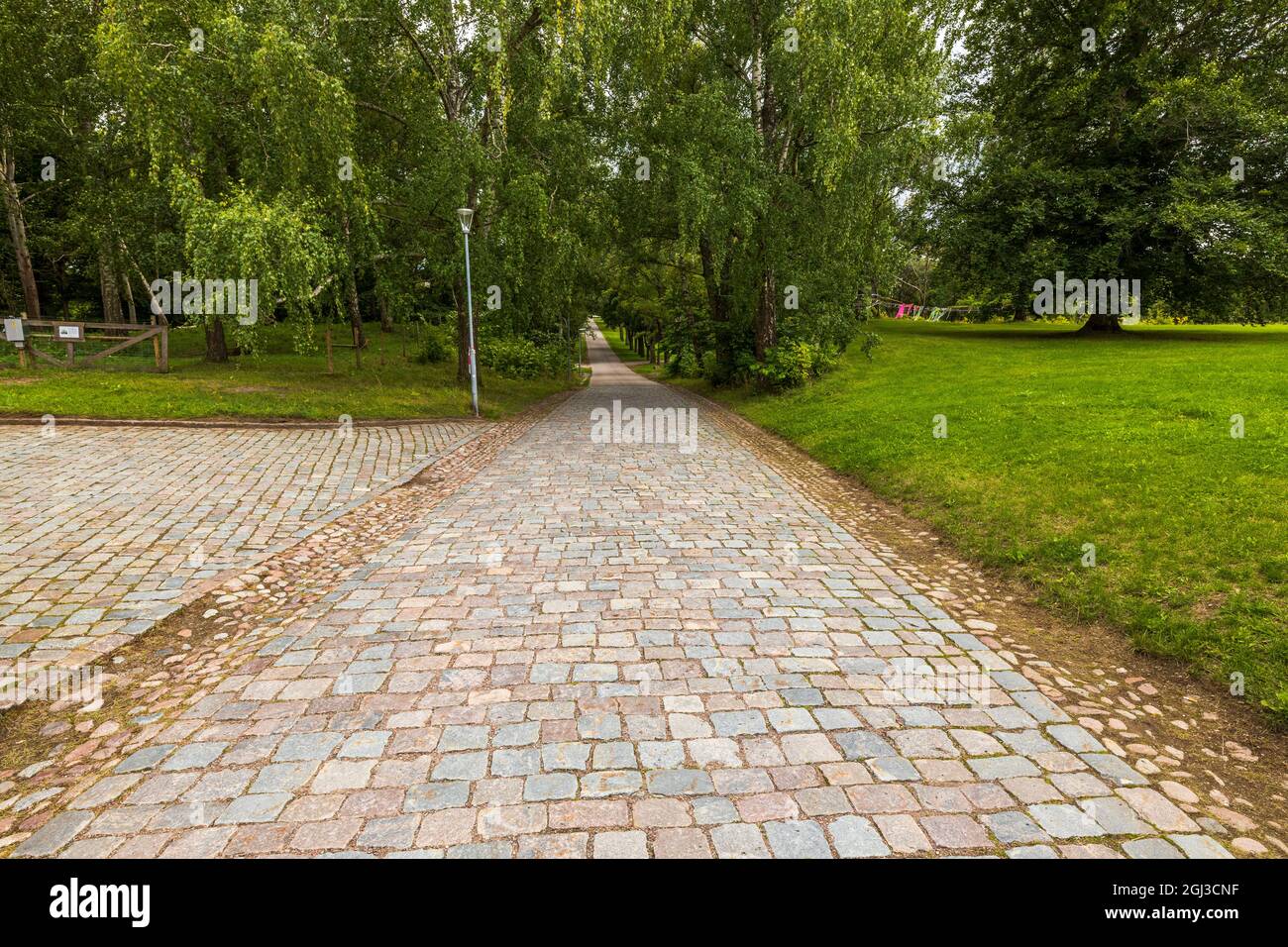 Beautiful view of park with old cobblestone pavement stone walkway ...