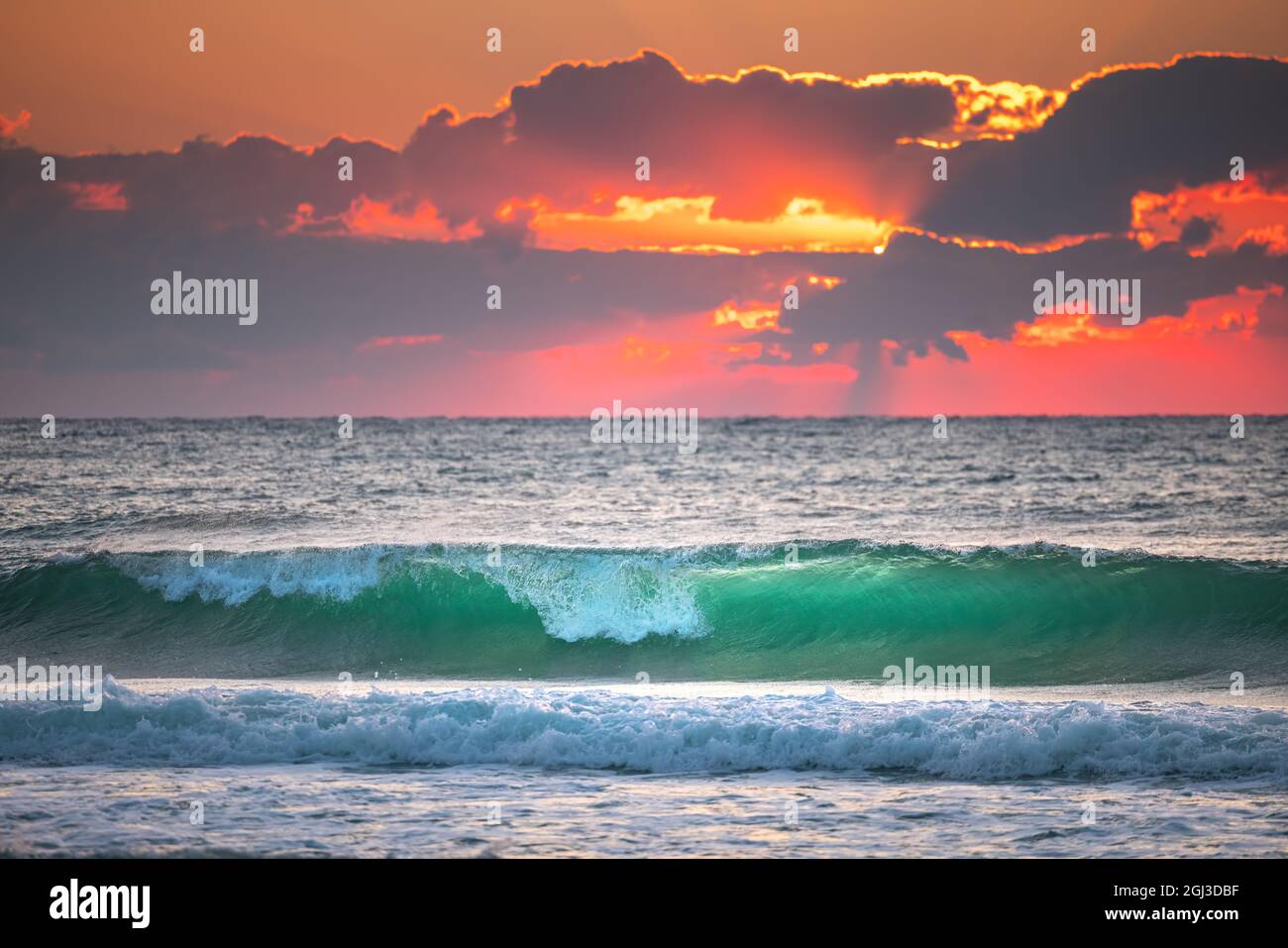Beautiful green sunrise wave Stock Photo - Alamy