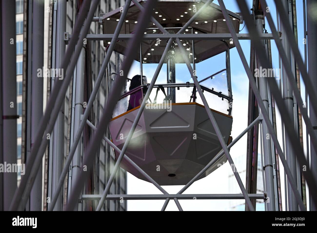 People are seen riding a ferris wheel setup along Broadway in Times ...