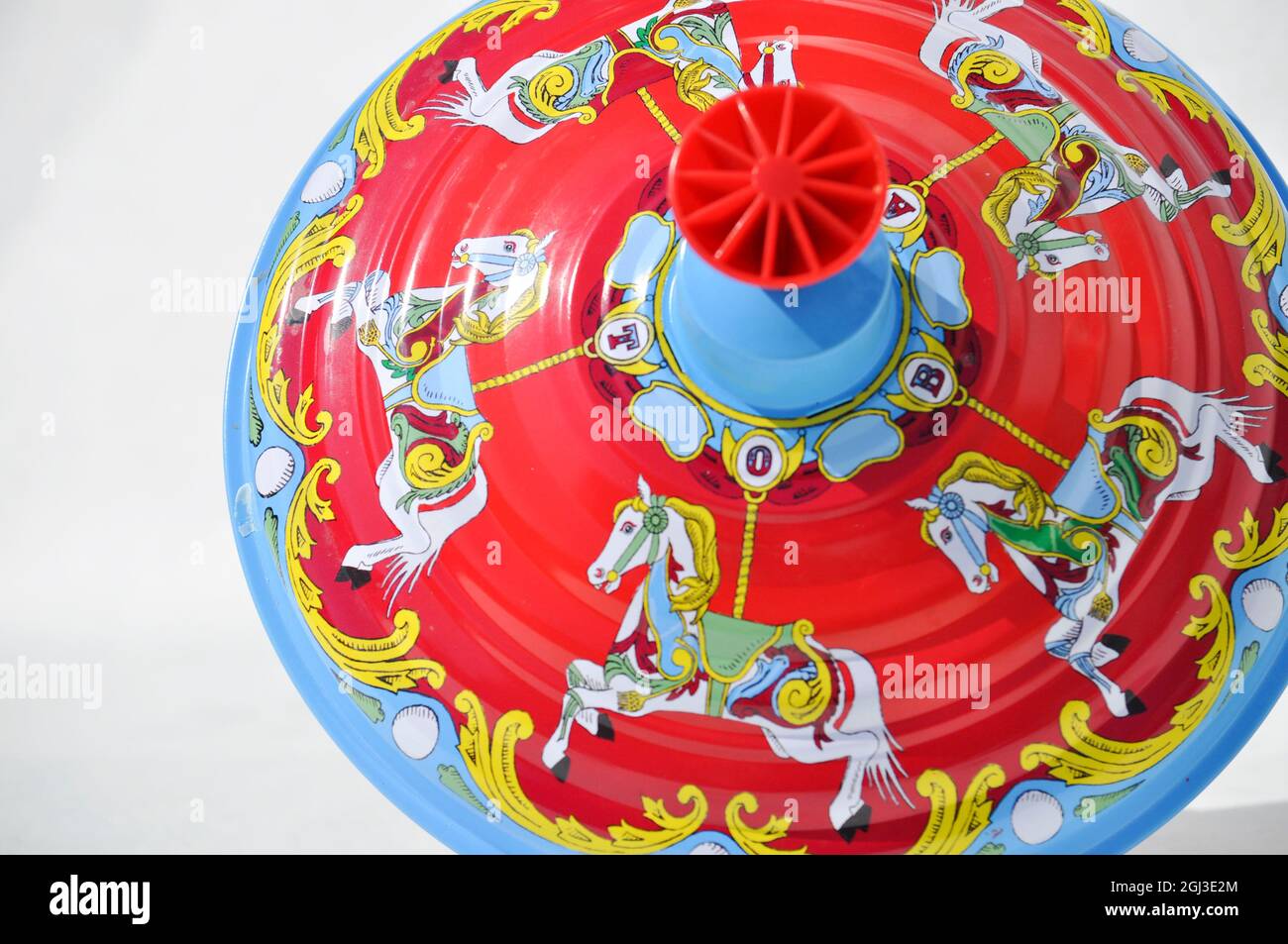 Brightly coloured spinning top toy set against a white background Stock ...