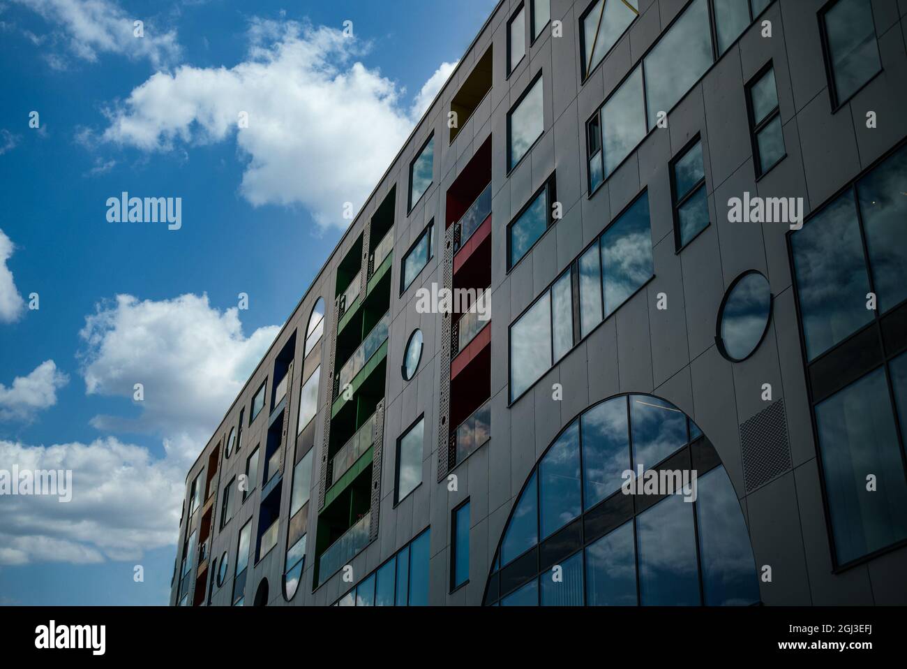 Modern architecture. House with a multi-colored facade and balconies ...