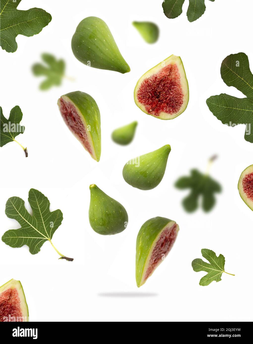 Fresh ripe whole and cut green Figs with leaves on white isolated ...