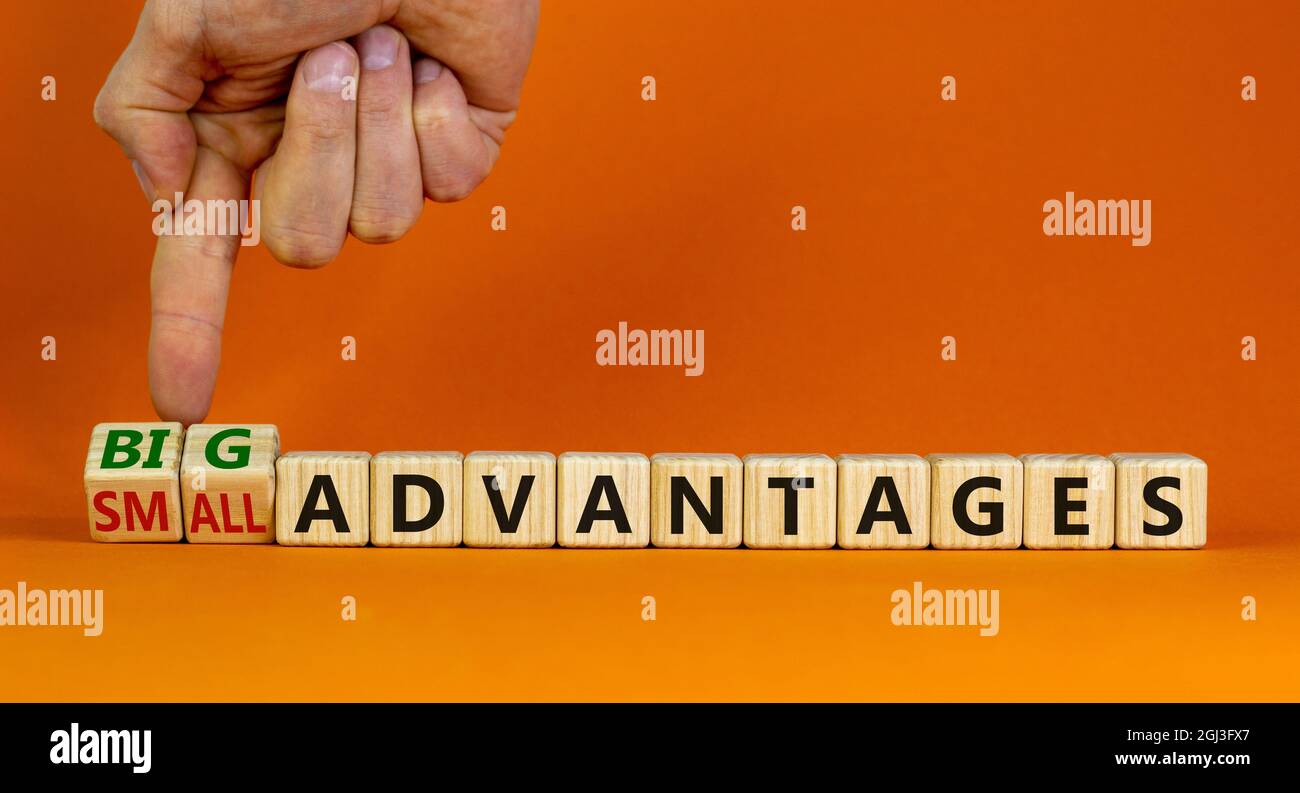 Big or small advantages symbol. Businessman turns wooden cubes, changes ...