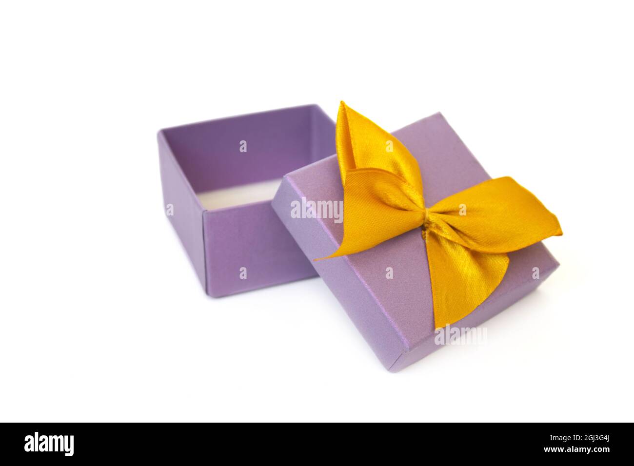 Blank open purple gift box with yellow ribbon bow isolated on white ...