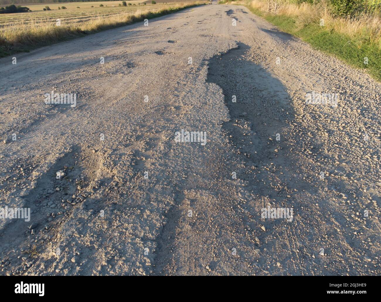 Rural asphalt road with potholes and potholes Stock Photo - Alamy