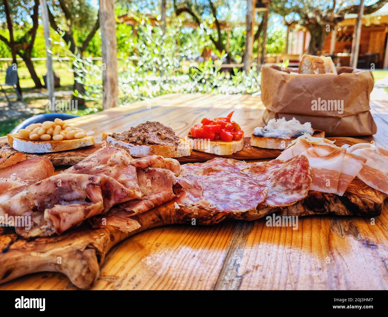 View of the platter of Italian cured meats and bruschetta on an outdoor ...