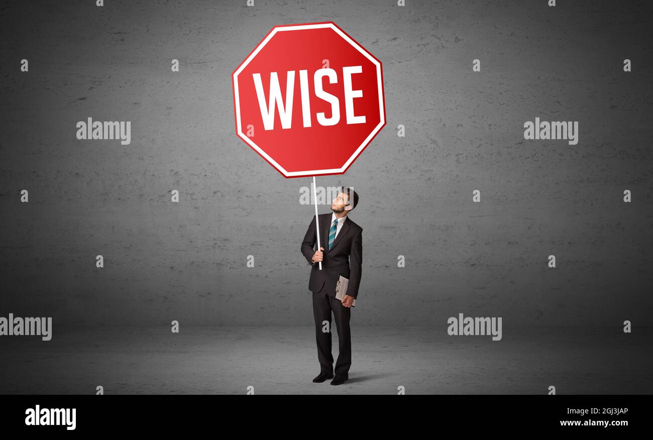 Young business person holding road sign Stock Photo - Alamy