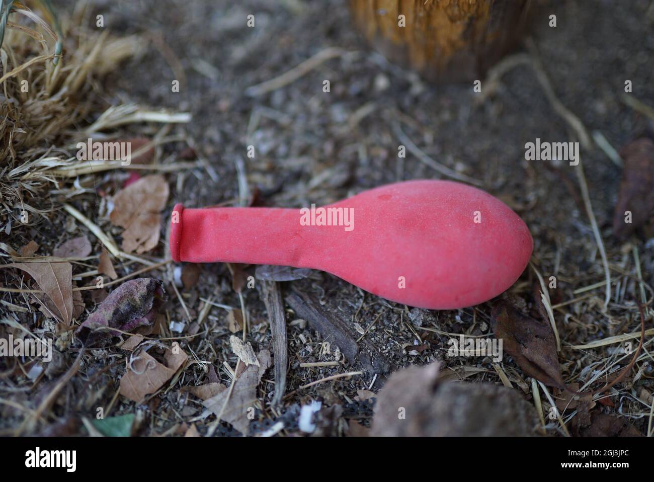 Closeup of a deflated rubber ball on the ground Stock Photo - Alamy
