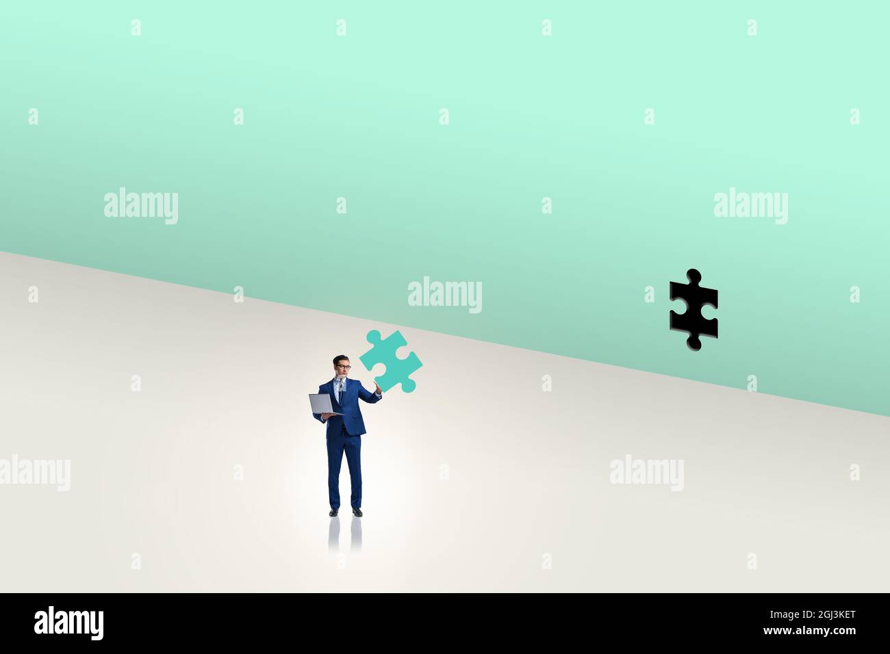 Businessman putting back missing jigsaw puzzle piece Stock Photo - Alamy