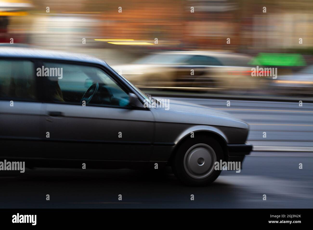 panning shot of a car with blurred background, taxi in the background ...