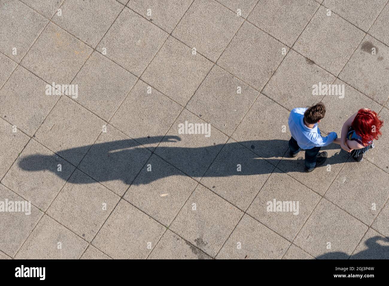 Long shadows of people created by low sun on a sunny September day in ...