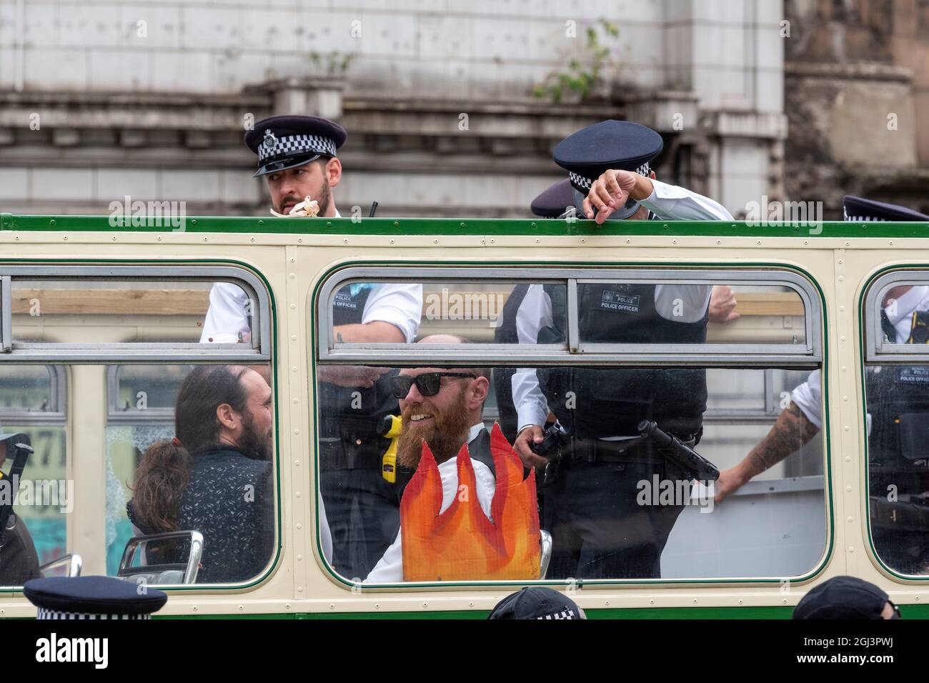 Police and protesters on a bus used to block the junction on the south ...