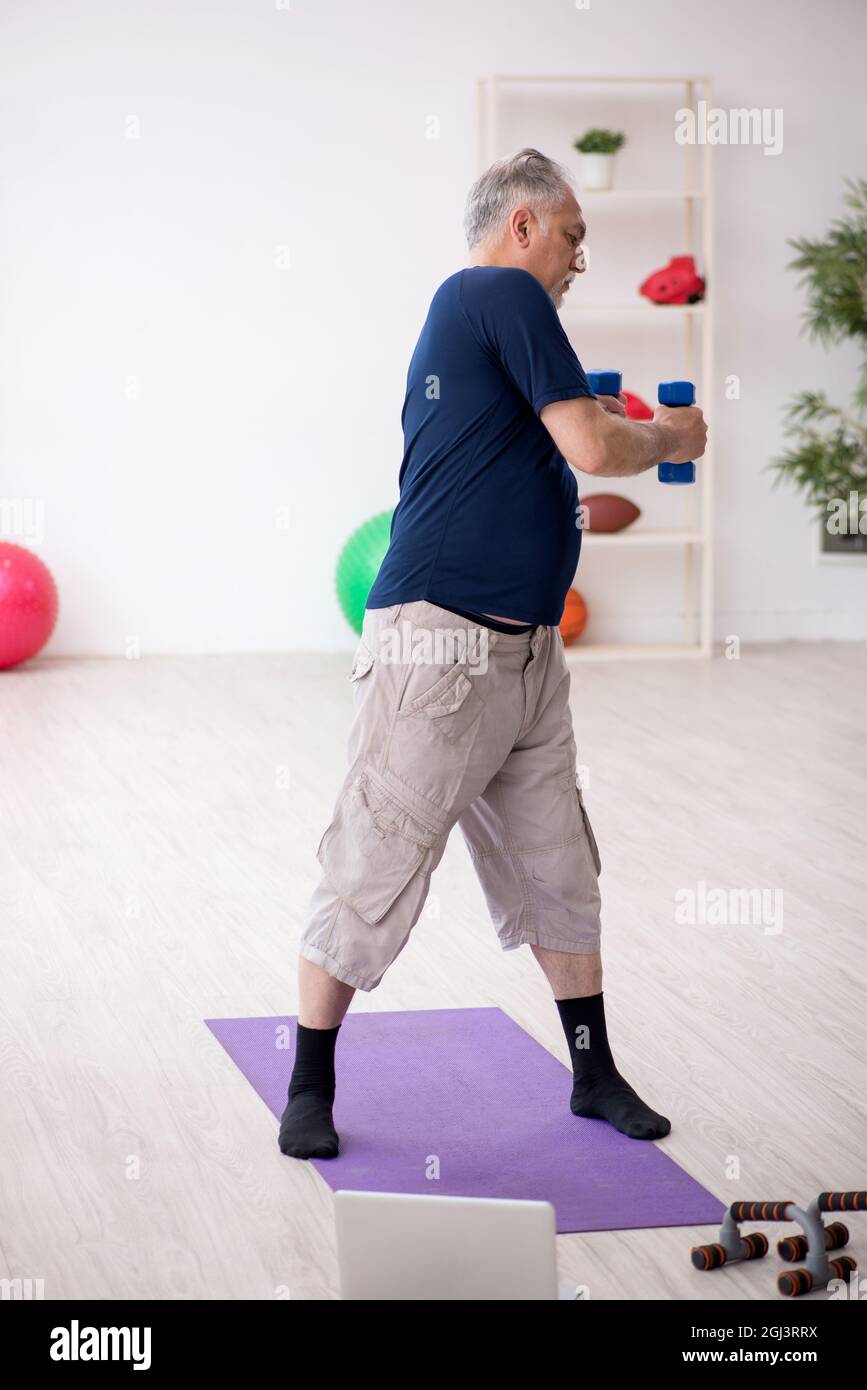 Old man doing sport exercises at home Stock Photo - Alamy