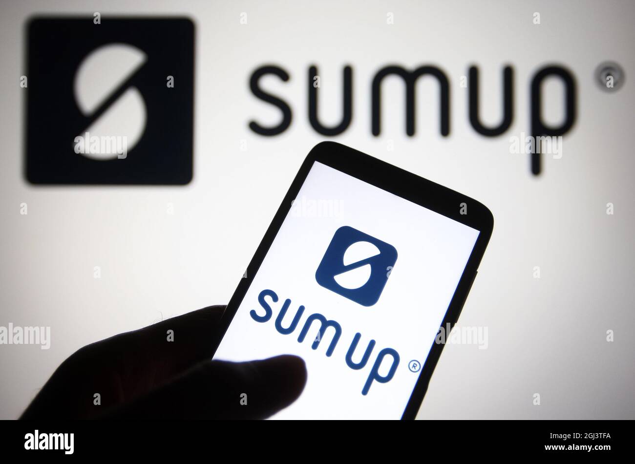 In this photo illustration a SumUp logo is seen on a smartphone and a ...