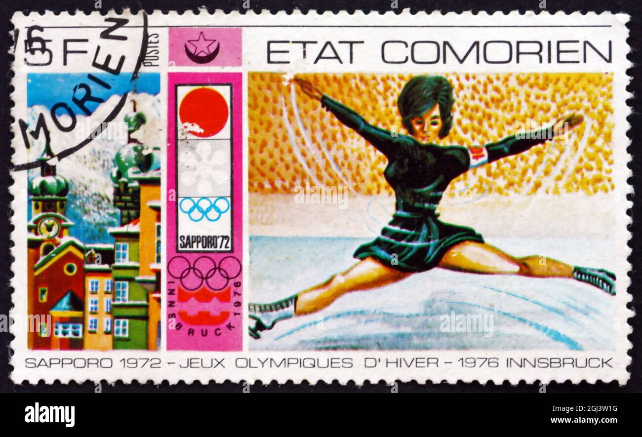 COMOROS - CIRCA 1976: a stamp printed in Comoros shows Women's Figure ...