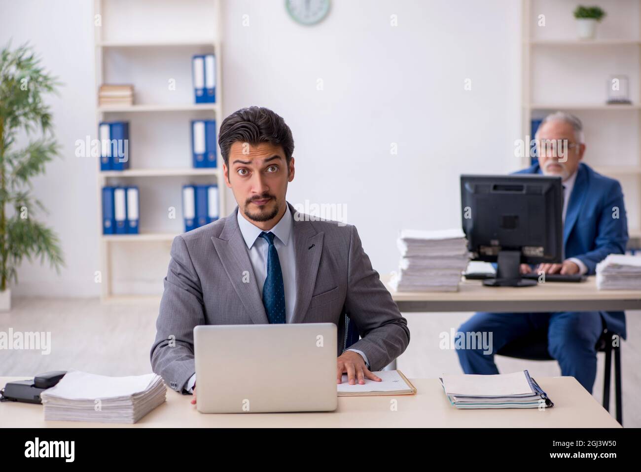 Two male employees working in the office Stock Photo - Alamy