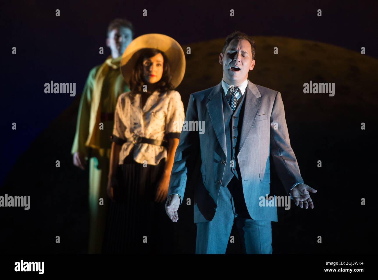 Actors and actresses are seen singing and performing on the stage ...