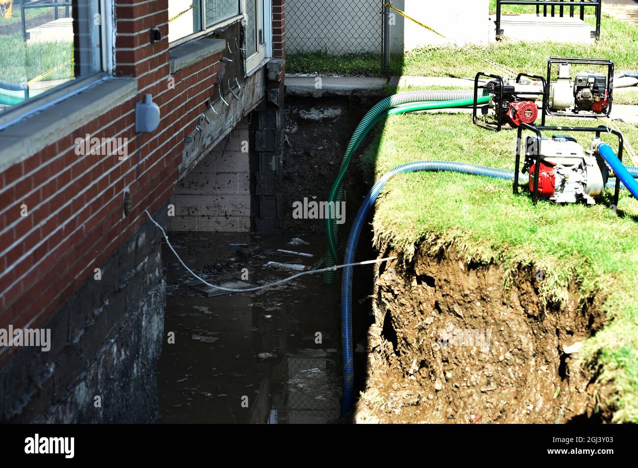 The fire department tries to pump water from a collapsed basement after ...