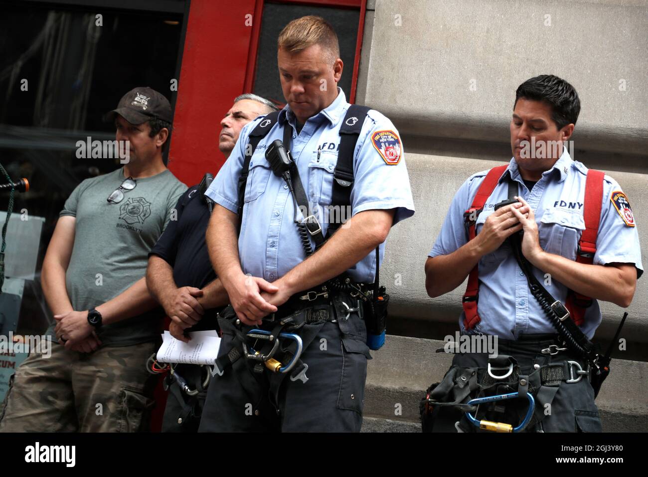 Members of the NYFD bow their heads during the reading of names for ...