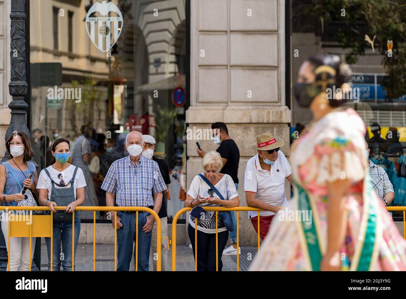 People wearing masks watch a parade during the awards ceremony in ...