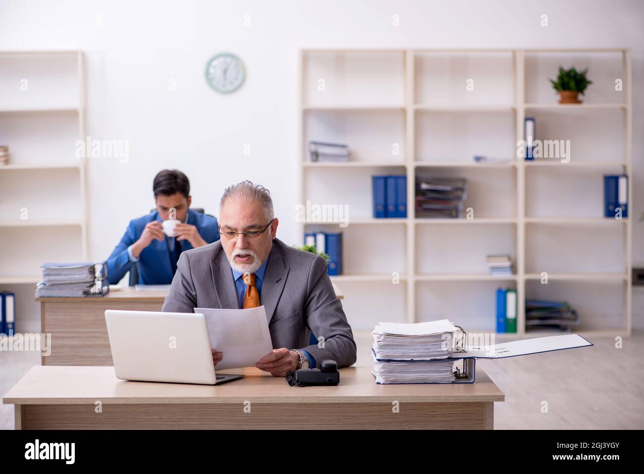 Two colleagues working at workplace Stock Photo - Alamy