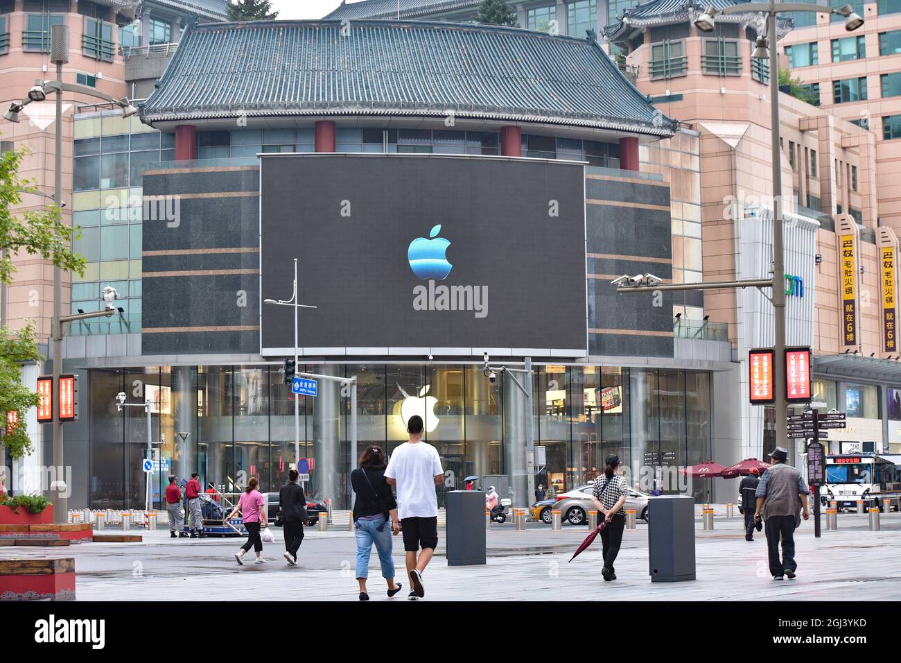 An Apple logo seen displayed on a large screen outside the Apple store ...