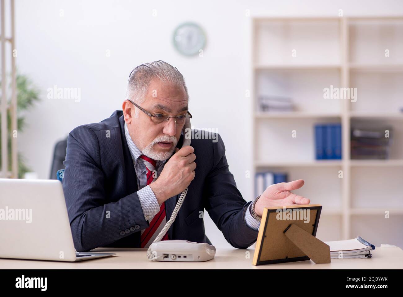 Old businessman employee missing wife at workplace Stock Photo - Alamy