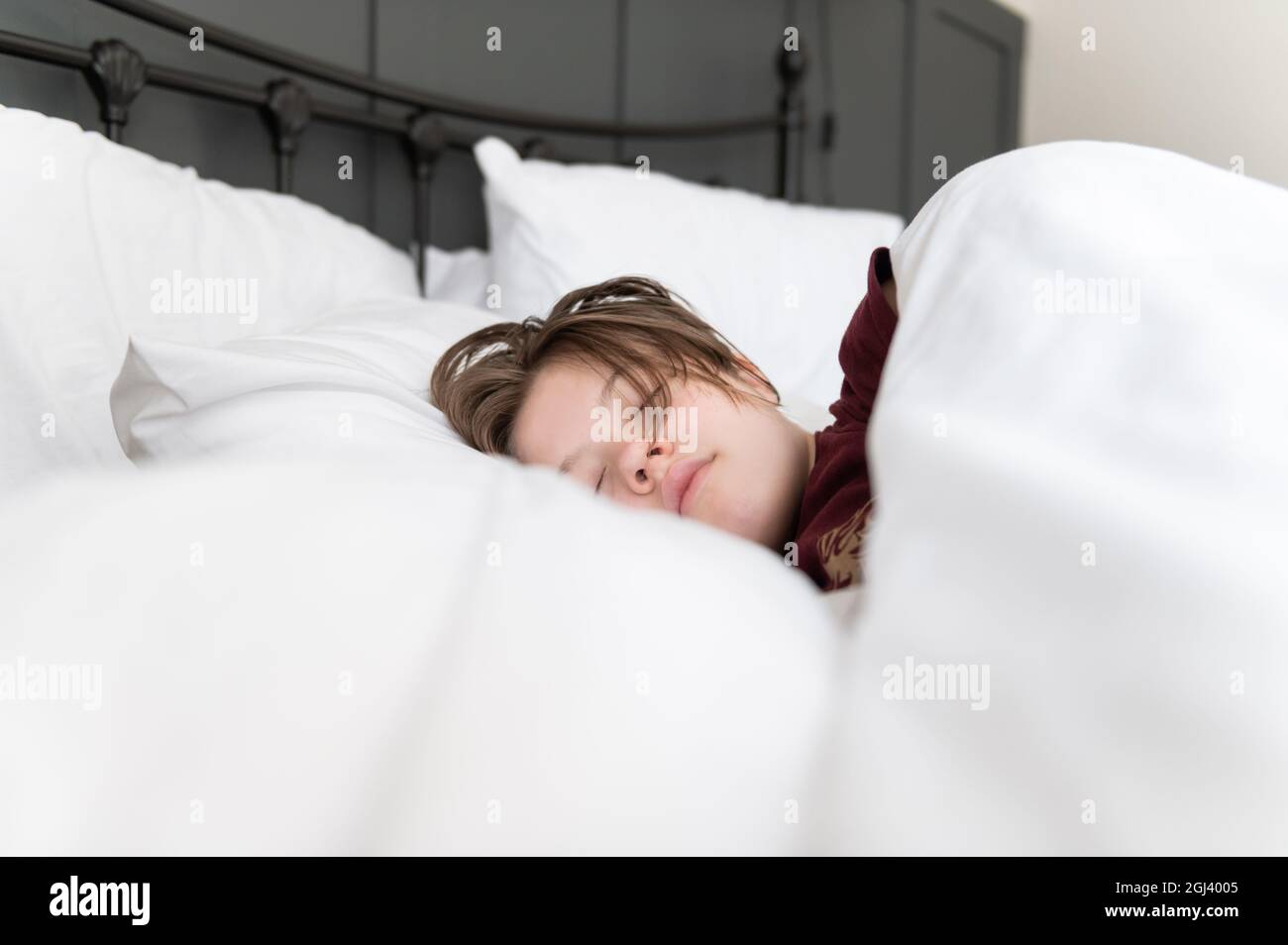 Sleepy teenager girl in bed Stock Photo - Alamy