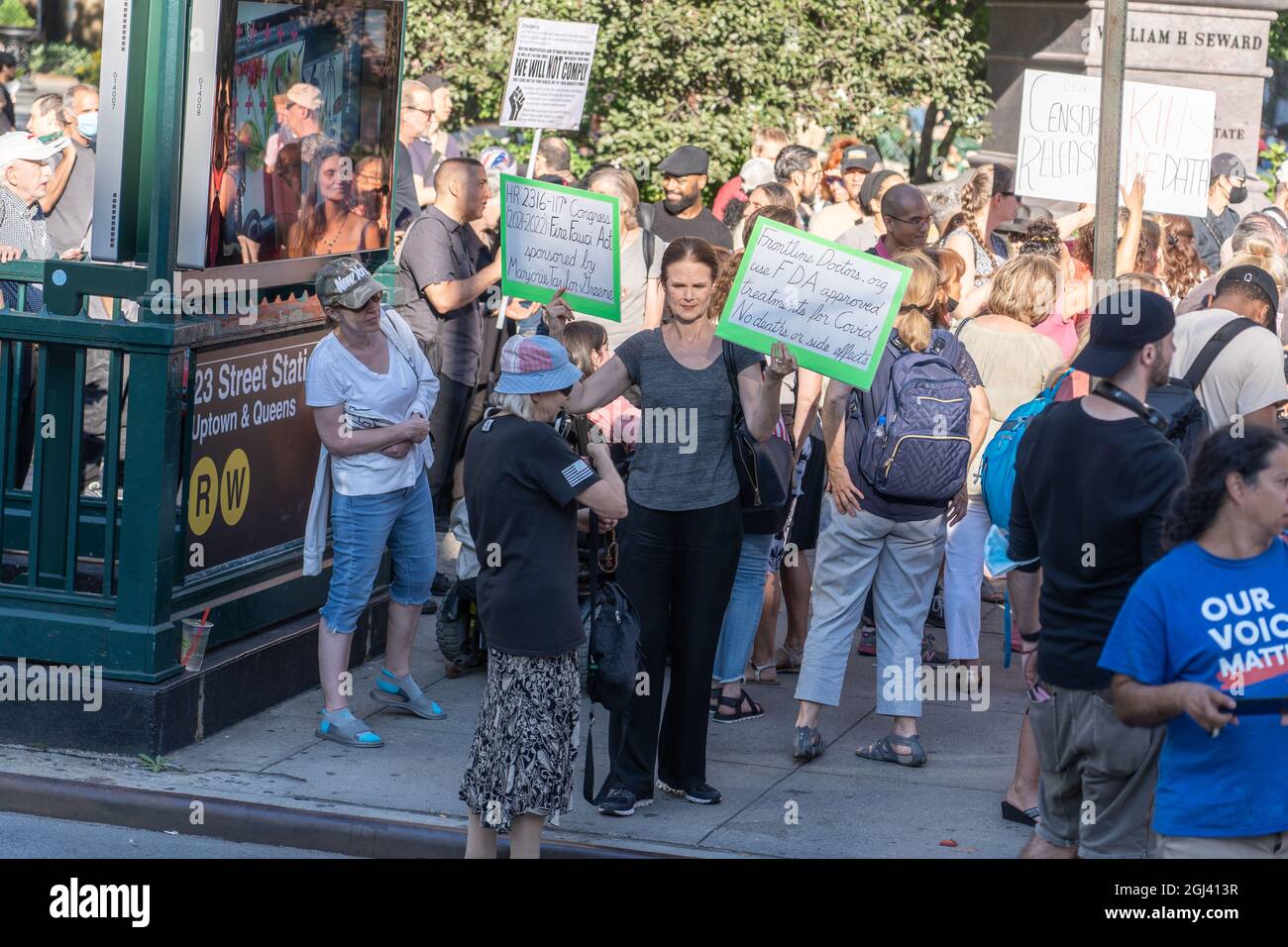 Anti-vaccination protesters holding placards and flags gather outside ...