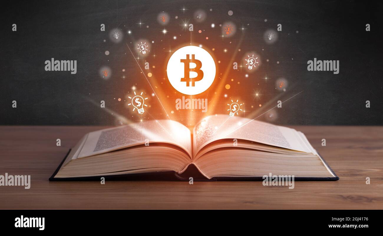Open book with currency icons above Stock Photo - Alamy