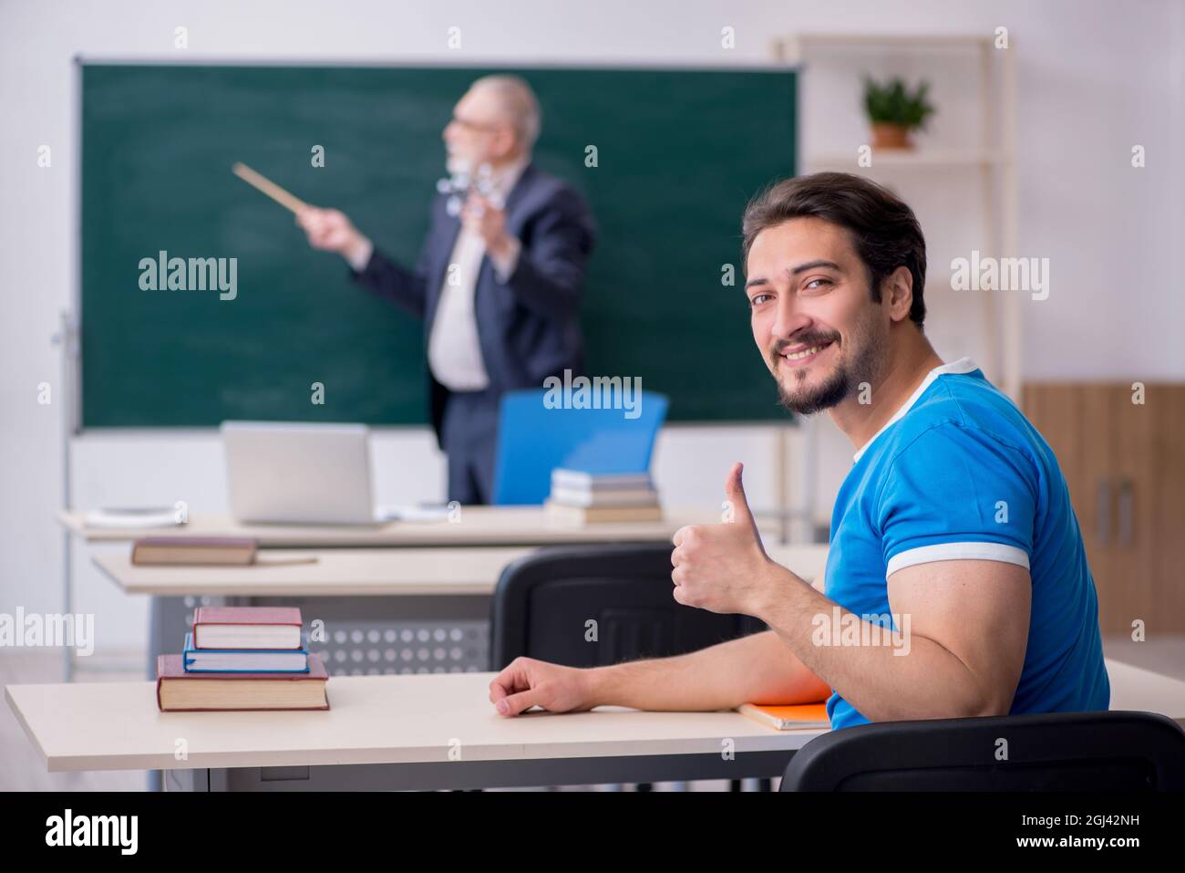 Old physics teacher and young male student in front of blackboard Stock ...