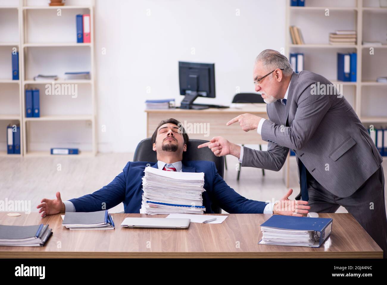 Two employees and too much work in the office Stock Photo - Alamy